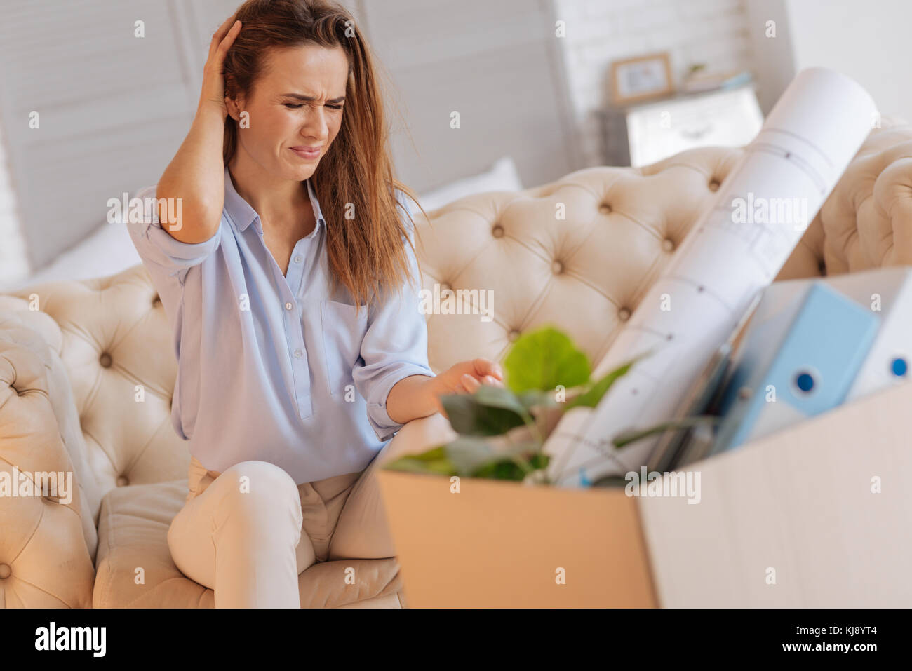 Sad young woman touching her hair while crying Stock Photo - Alamy