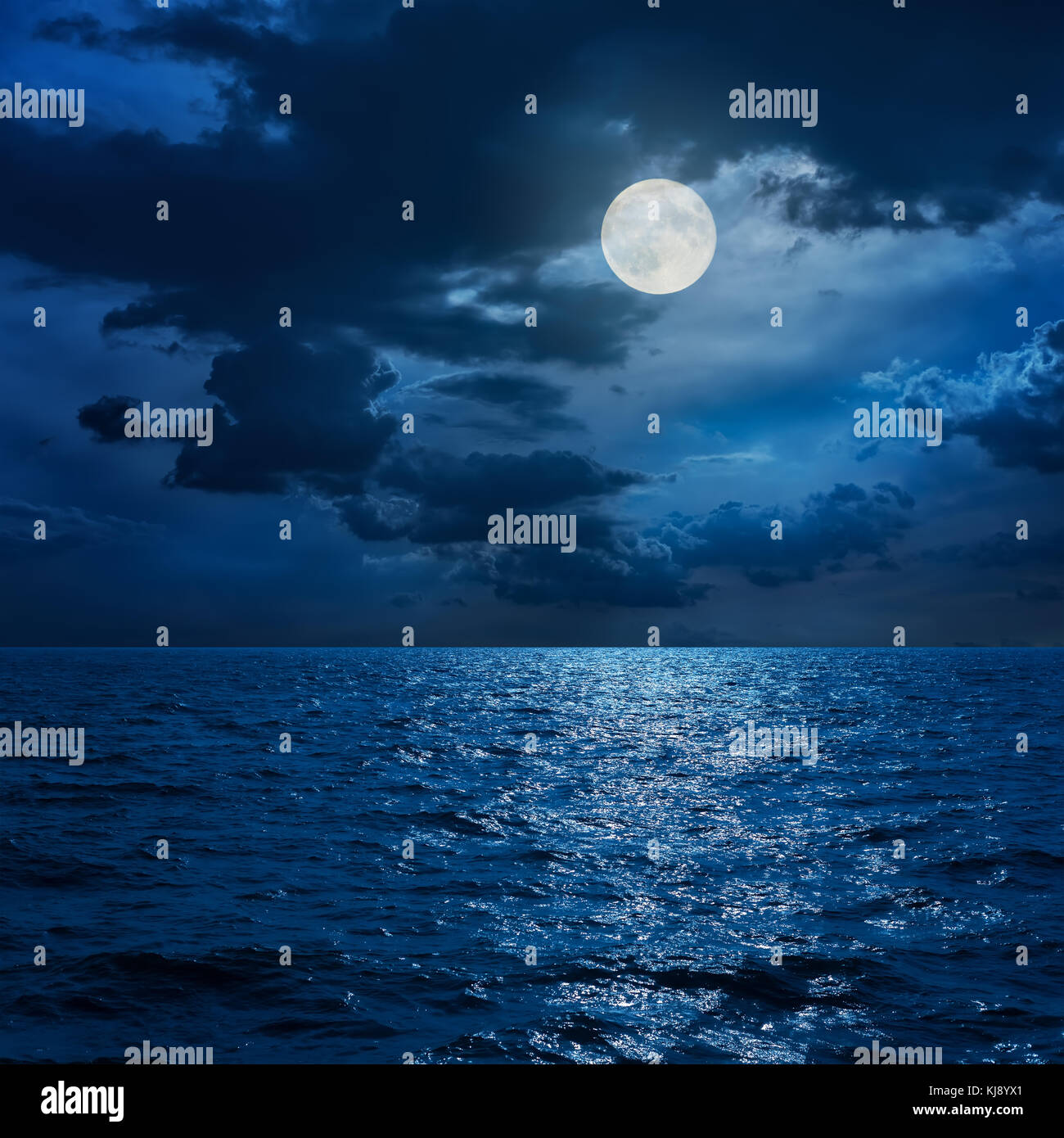 full moon in clouds over sea in night Stock Photo - Alamy