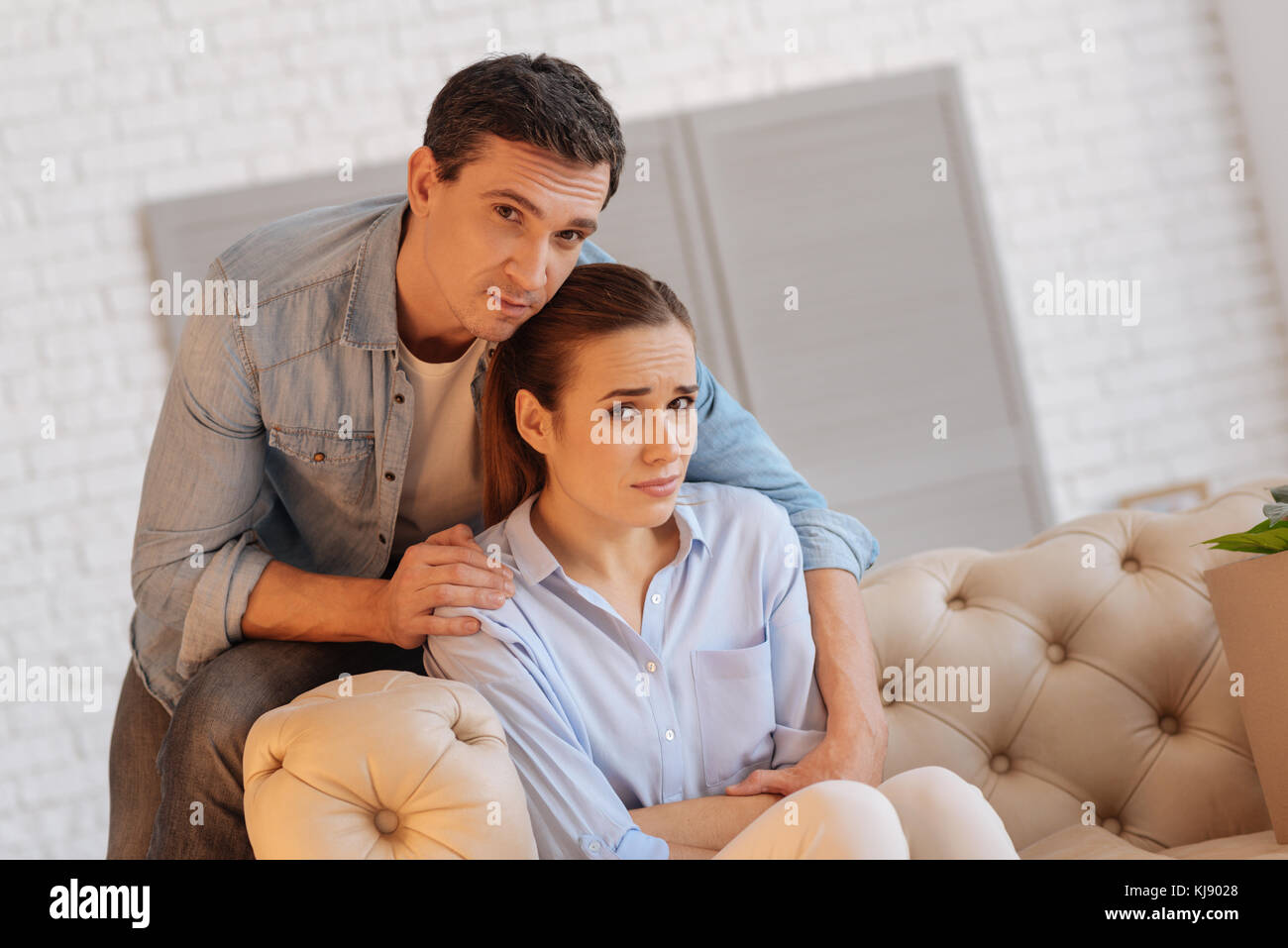 Upset young woman spending time with her loving husband Stock Photo - Alamy