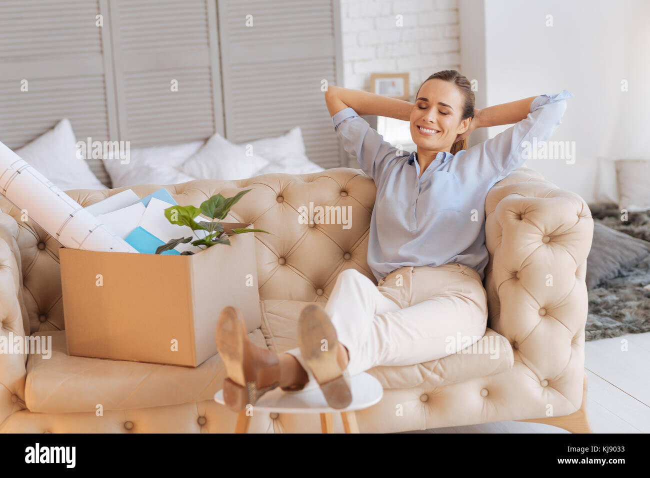 Pleased young woman feeling good while being at home Stock Photo - Alamy
