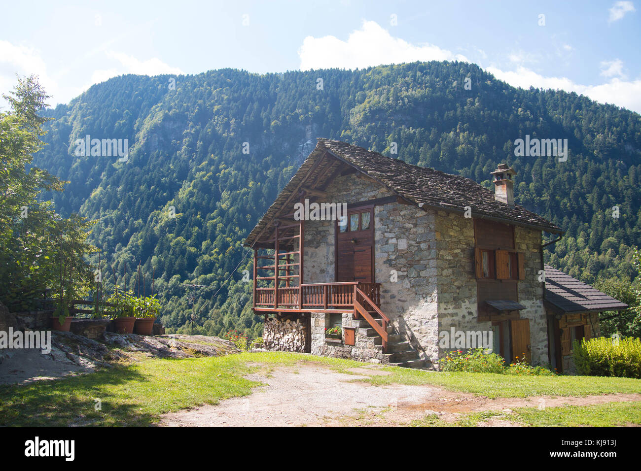 Stone chalet in mountain landscape Stock Photo - Alamy