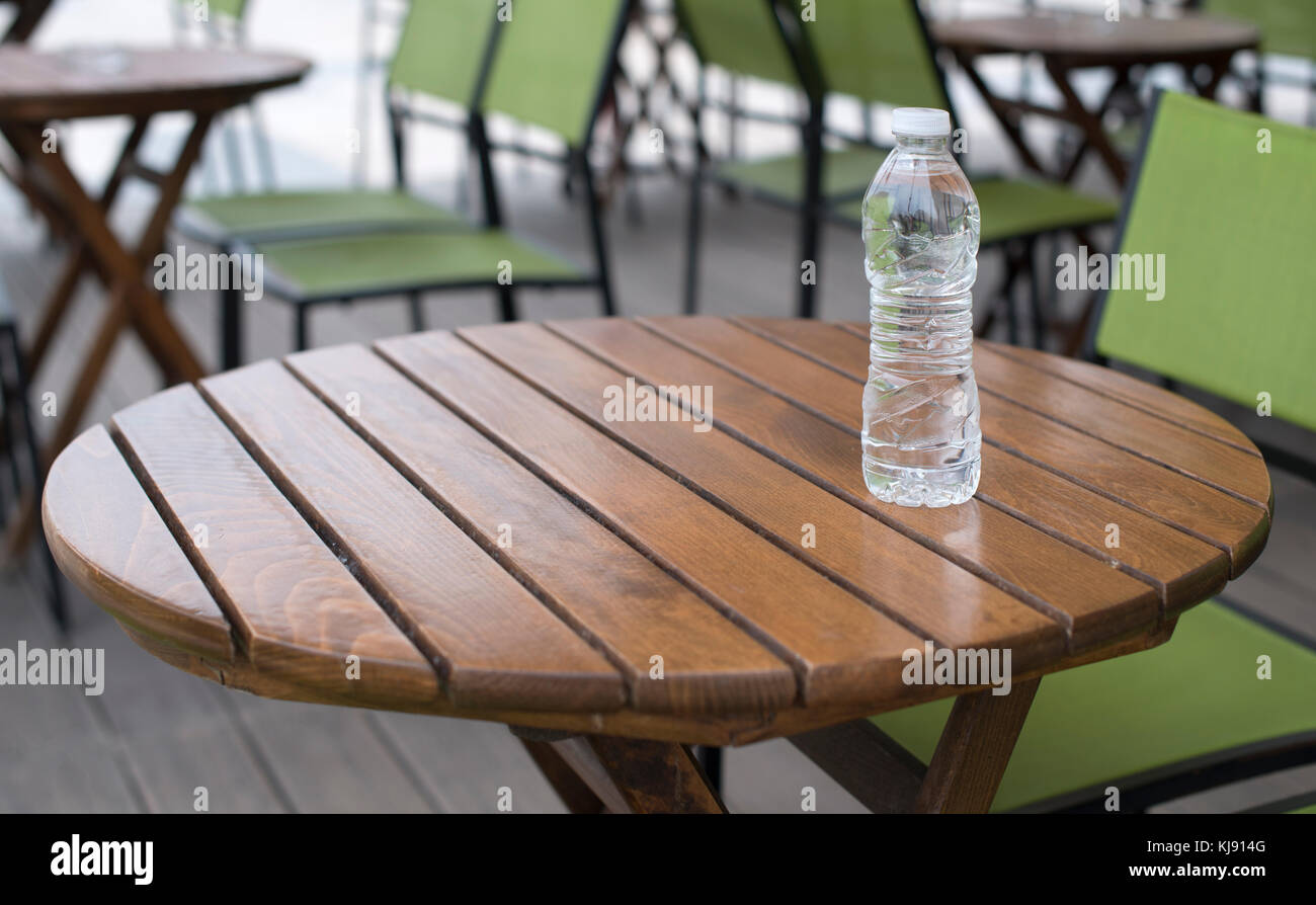 Bottle mineral water on wooden table in restaurant Stock Photo - Alamy