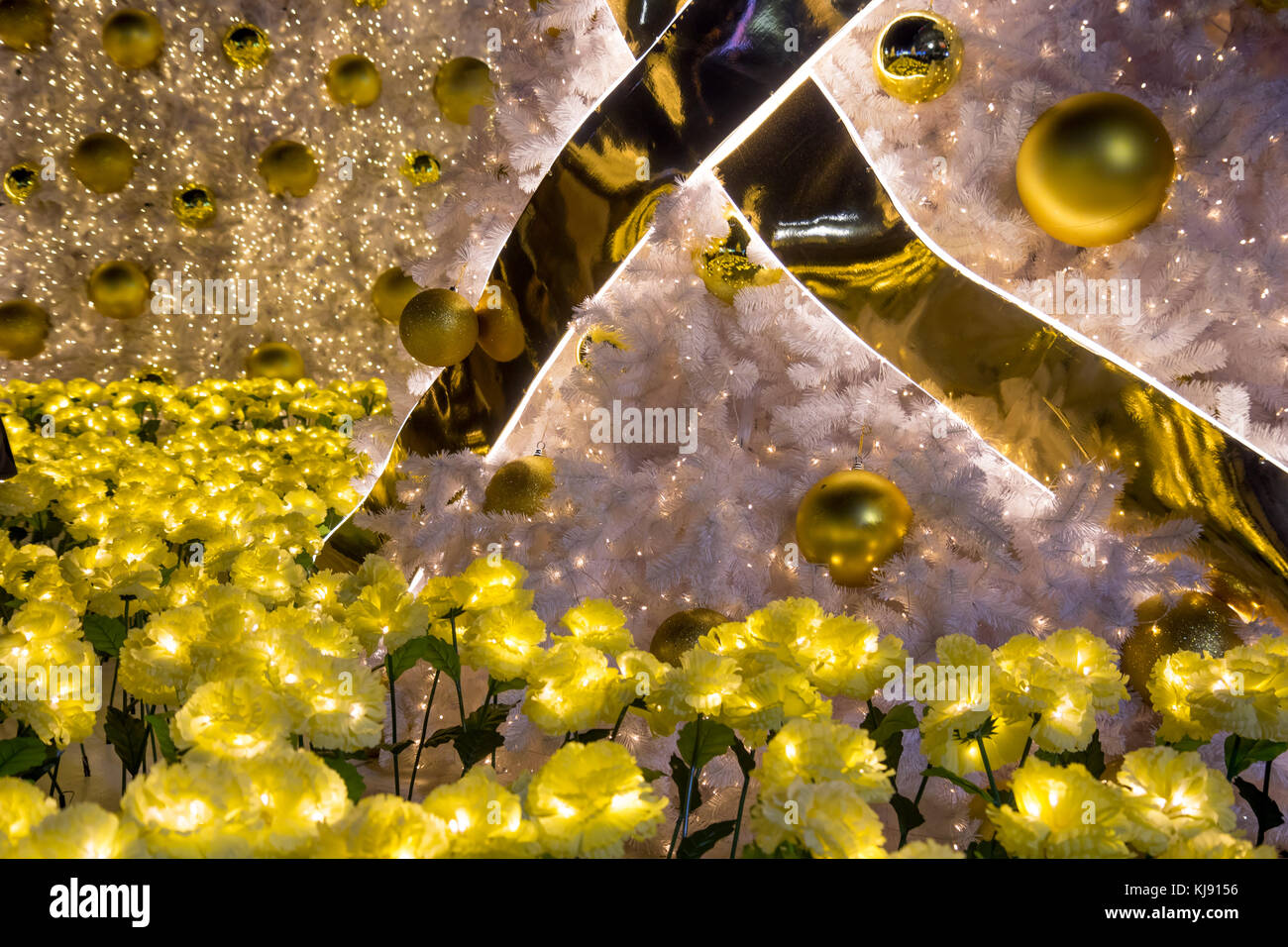 Golden decoration on a Christmas tree with a yellow lights flower ...
