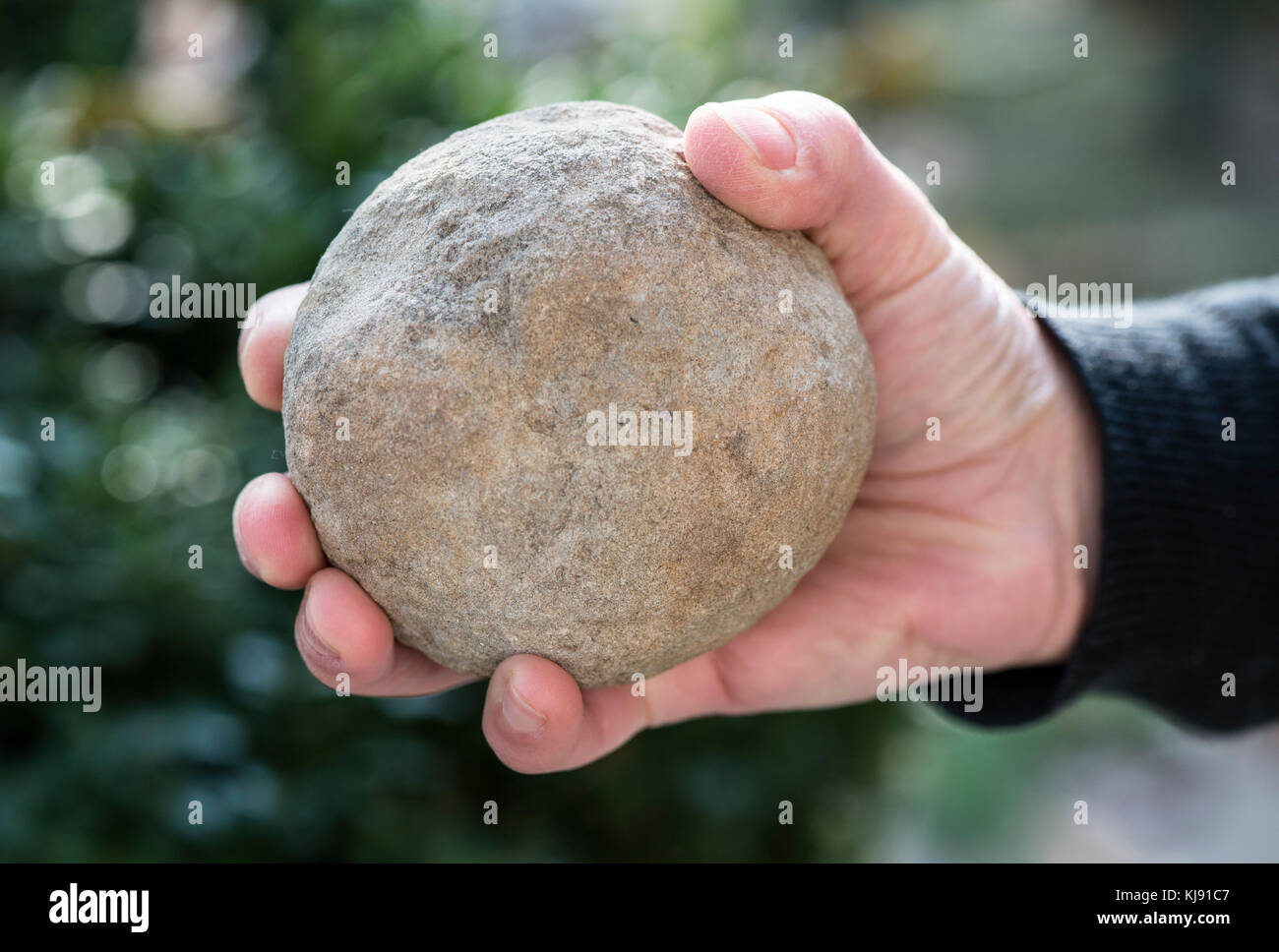 Hand holding stone ball piece hi-res stock photography and images - Alamy