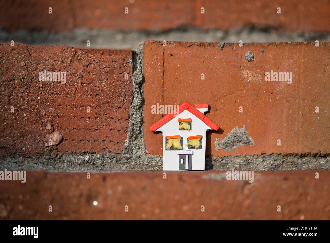 House miniature and brick wall. Paper house Stock Photo - Alamy