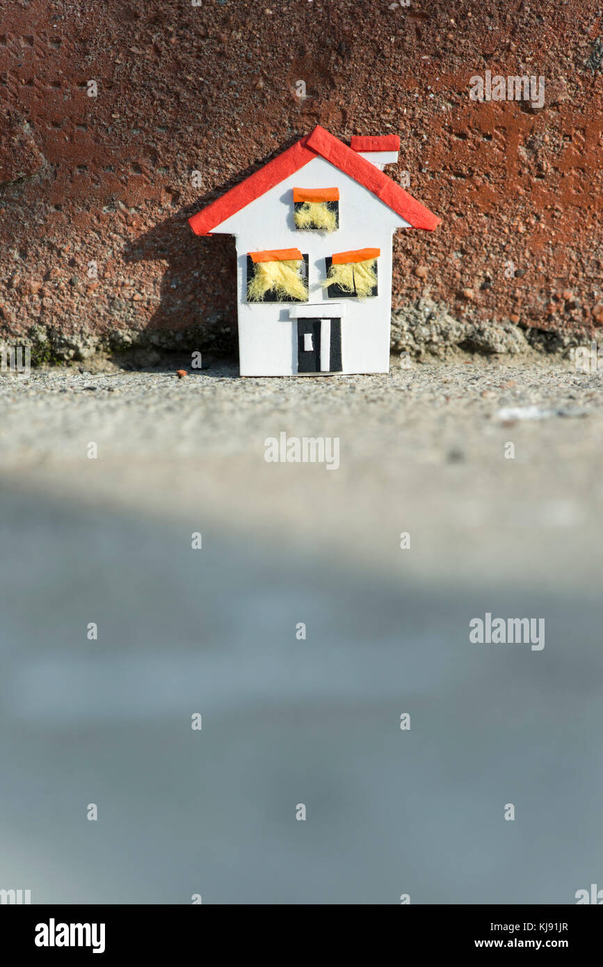House miniature and brick wall. Paper house Stock Photo - Alamy