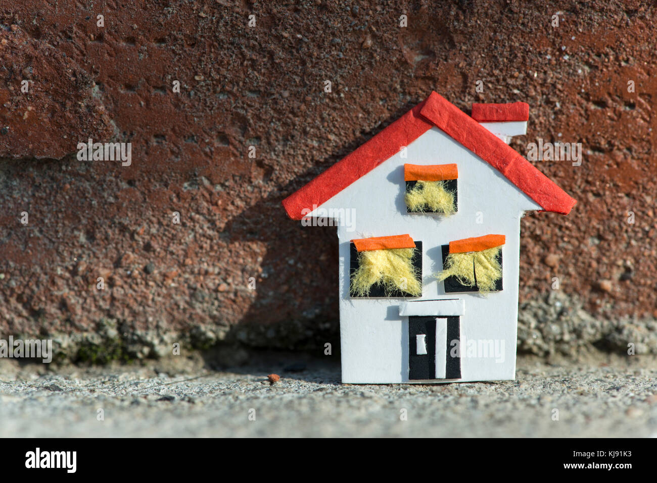 House miniature and brick wall. Paper house Stock Photo - Alamy