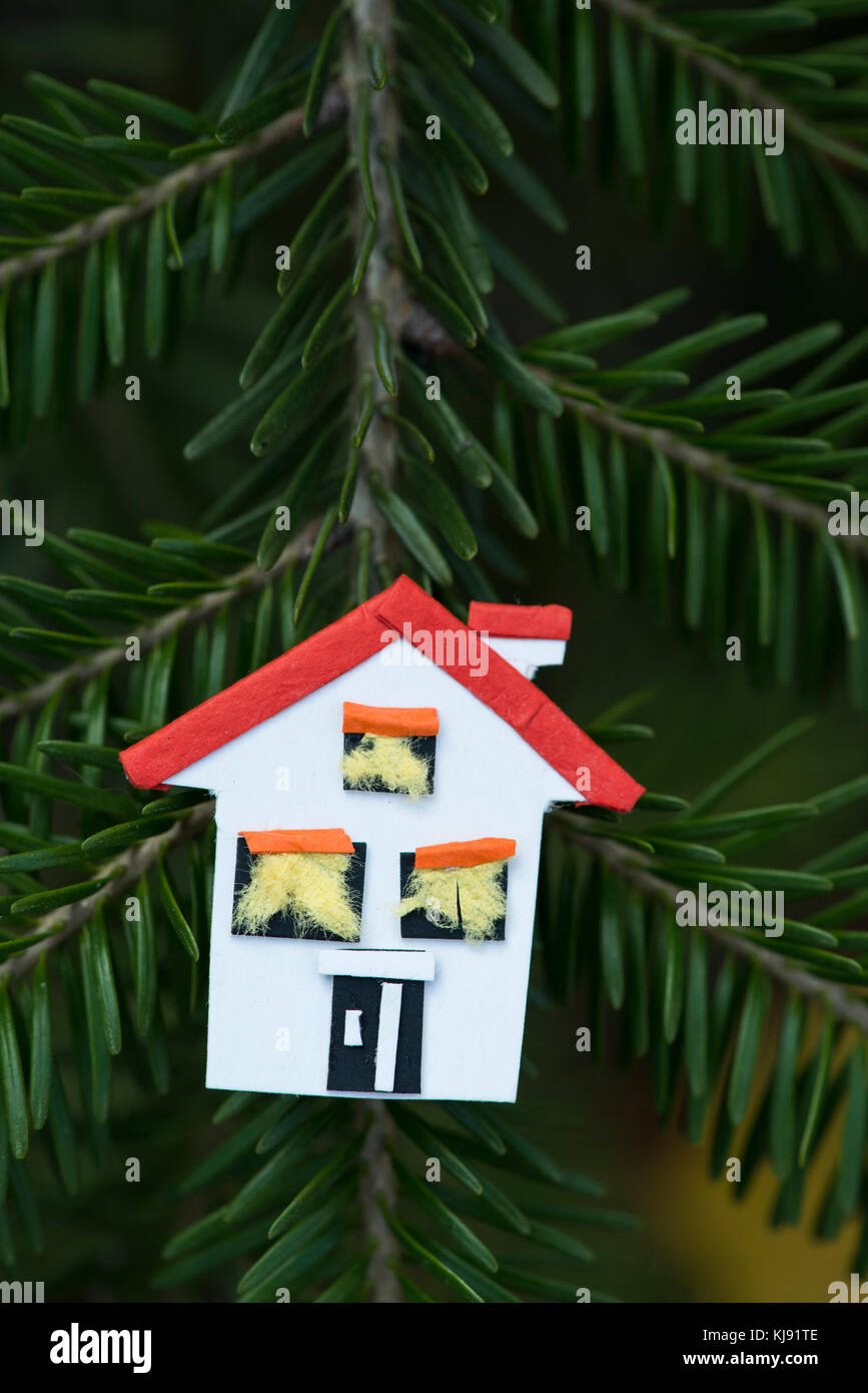 House miniature on fir tree. Paper house Stock Photo - Alamy