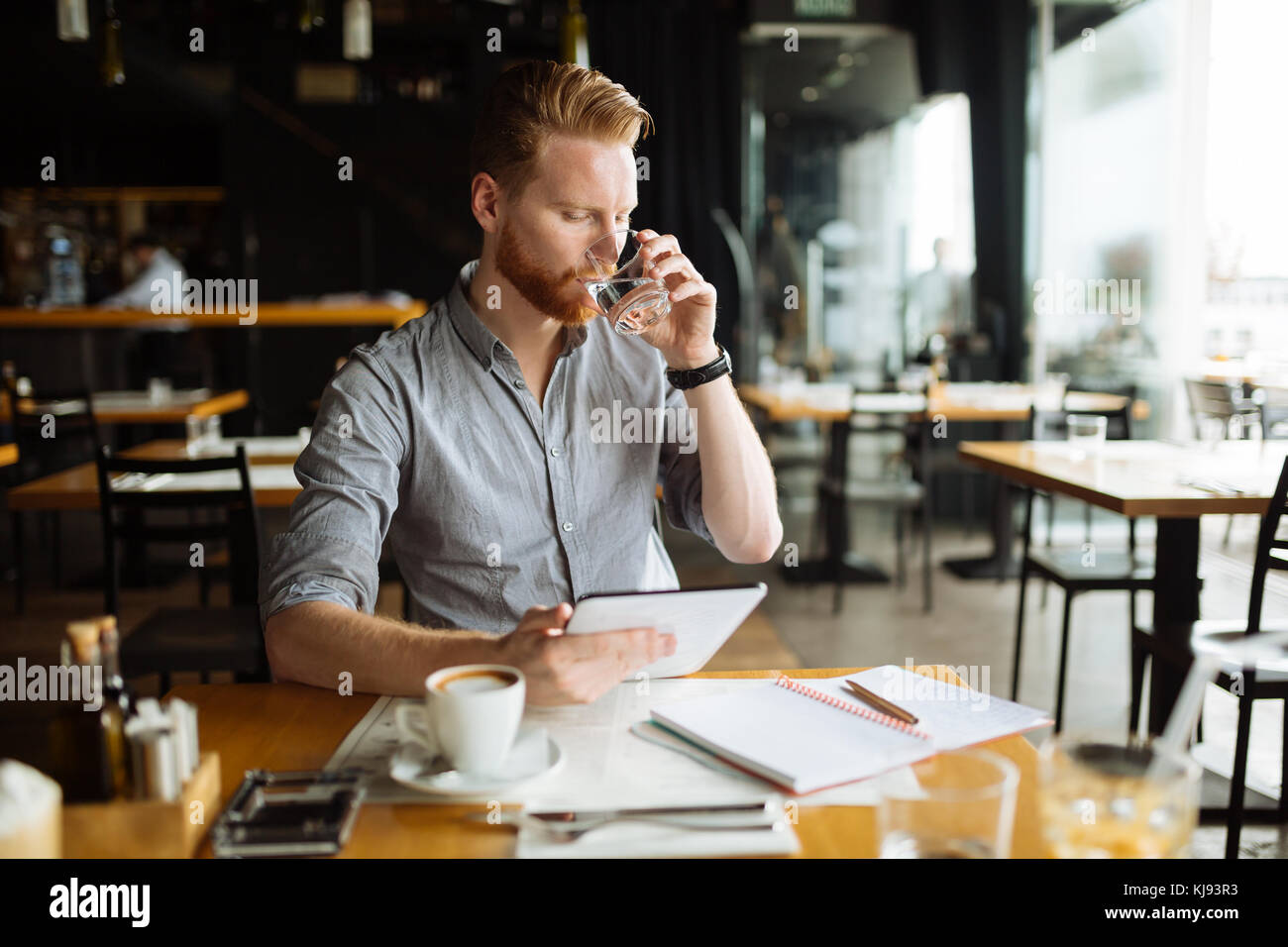 Businessman reading on break Stock Photo - Alamy