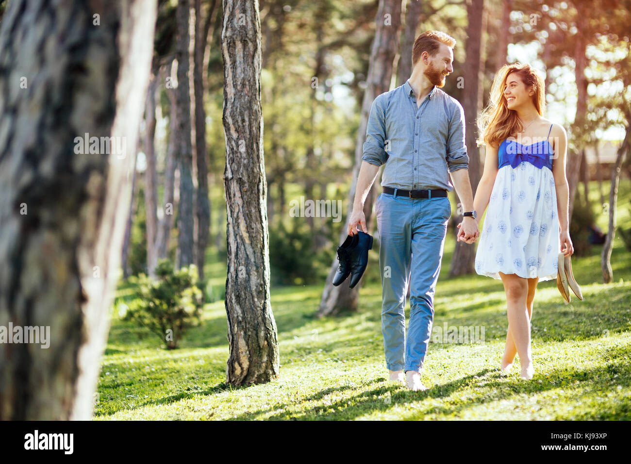 Romantic couple walking forest Stock Photo - Alamy