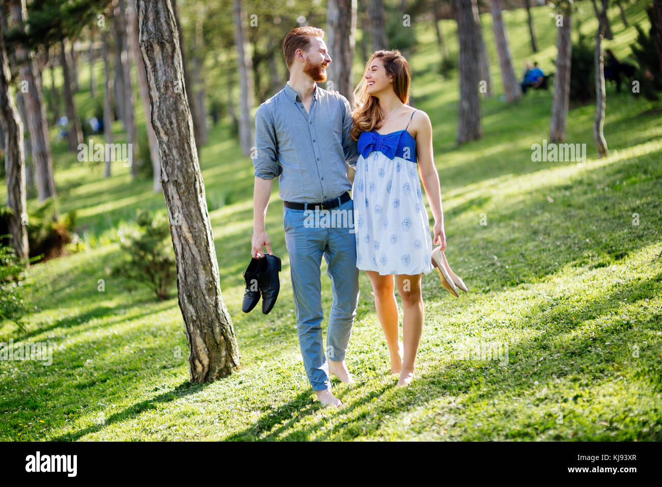Romantic couple walking forest Stock Photo - Alamy
