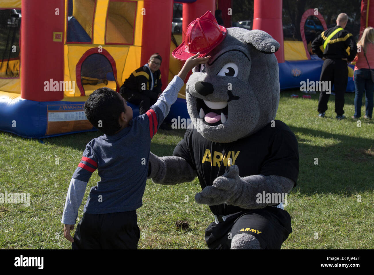Tiou places a fire hat on Sgt. Rocky, 3rd Infantry Division's mascot ...