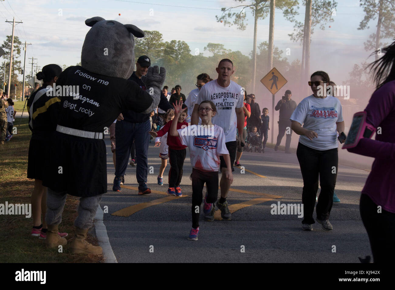 Sgt. Rocky, 3rd Infantry Division's mascot, high fives a young girl ...