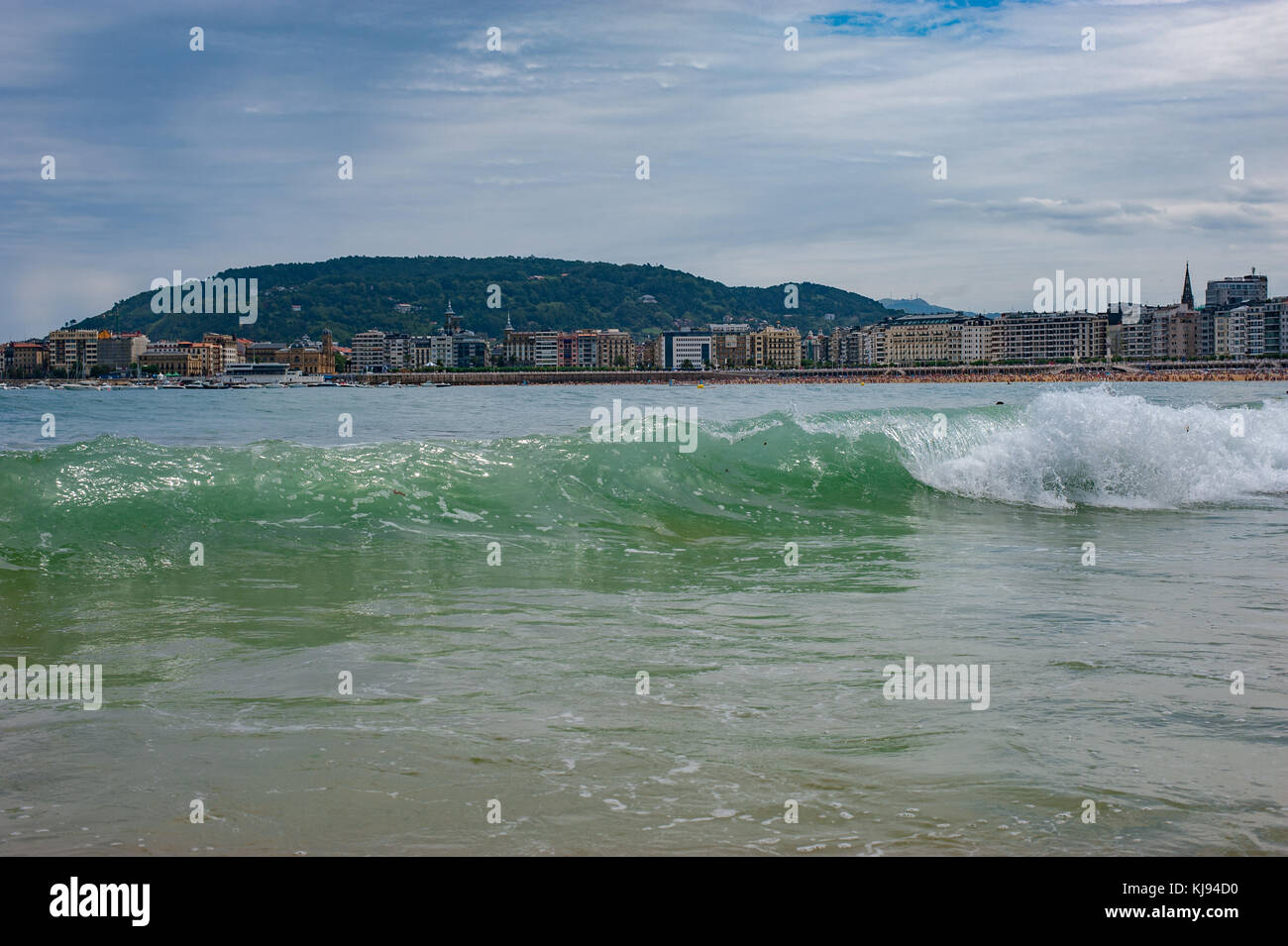 Beautiful turquoise waves crushing on a beach of a small Spanish town ...