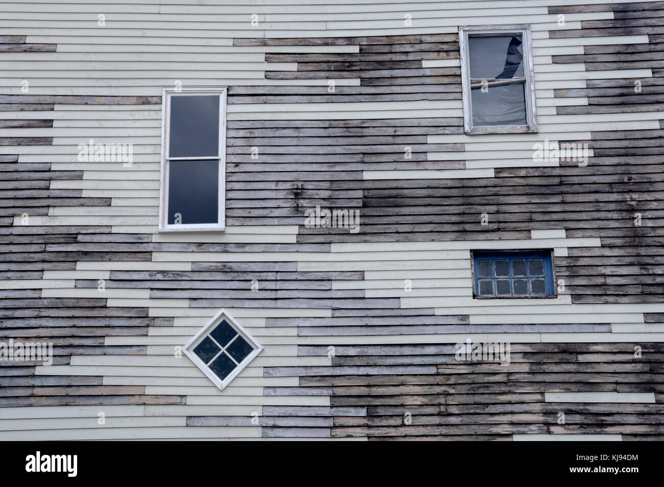 Oddly placed windows and clapboards on the side of a quirky house Stock ...