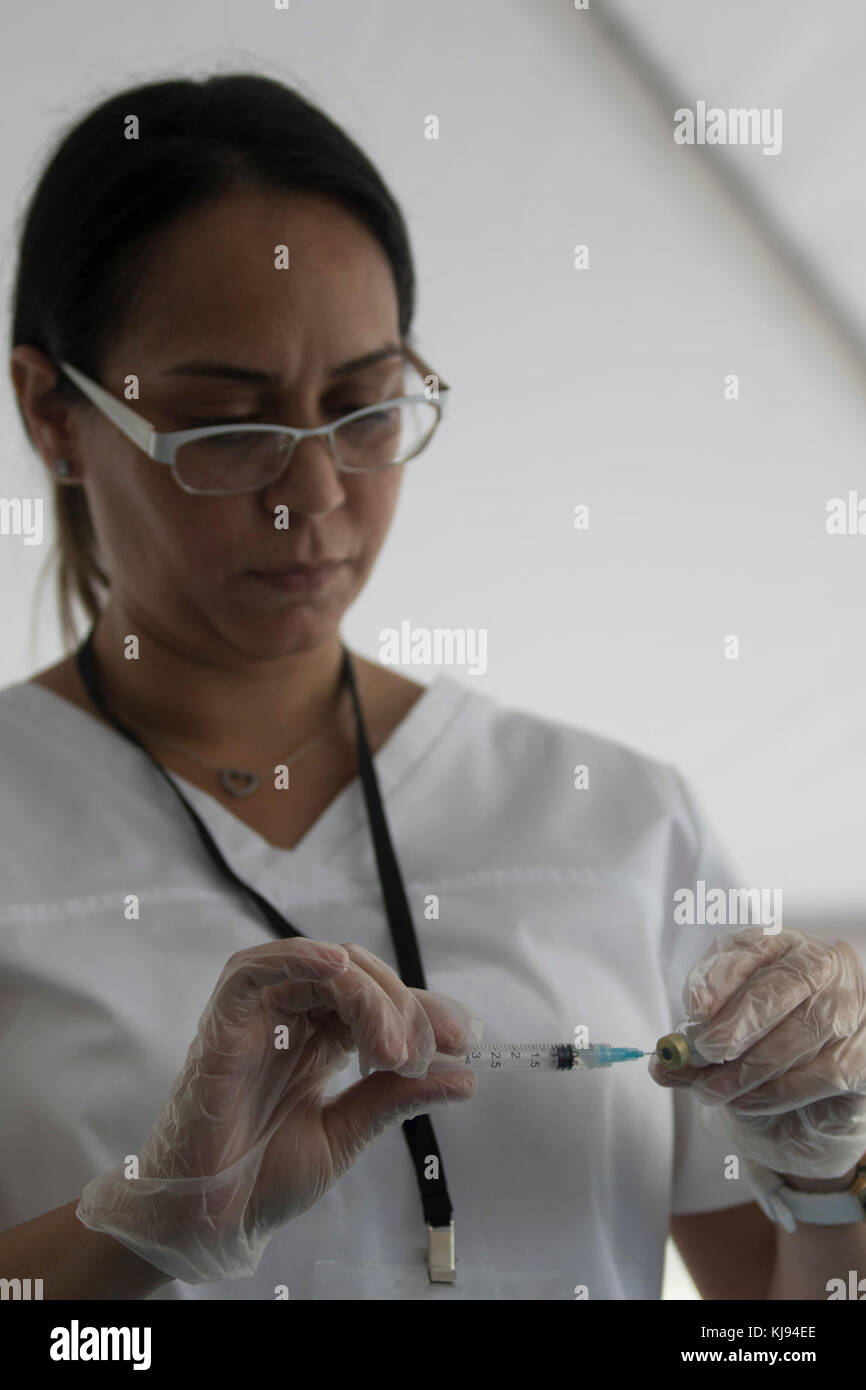 SAN JUAN, Puerto Rico – A local nurse draws vaccine from a vial at an ...