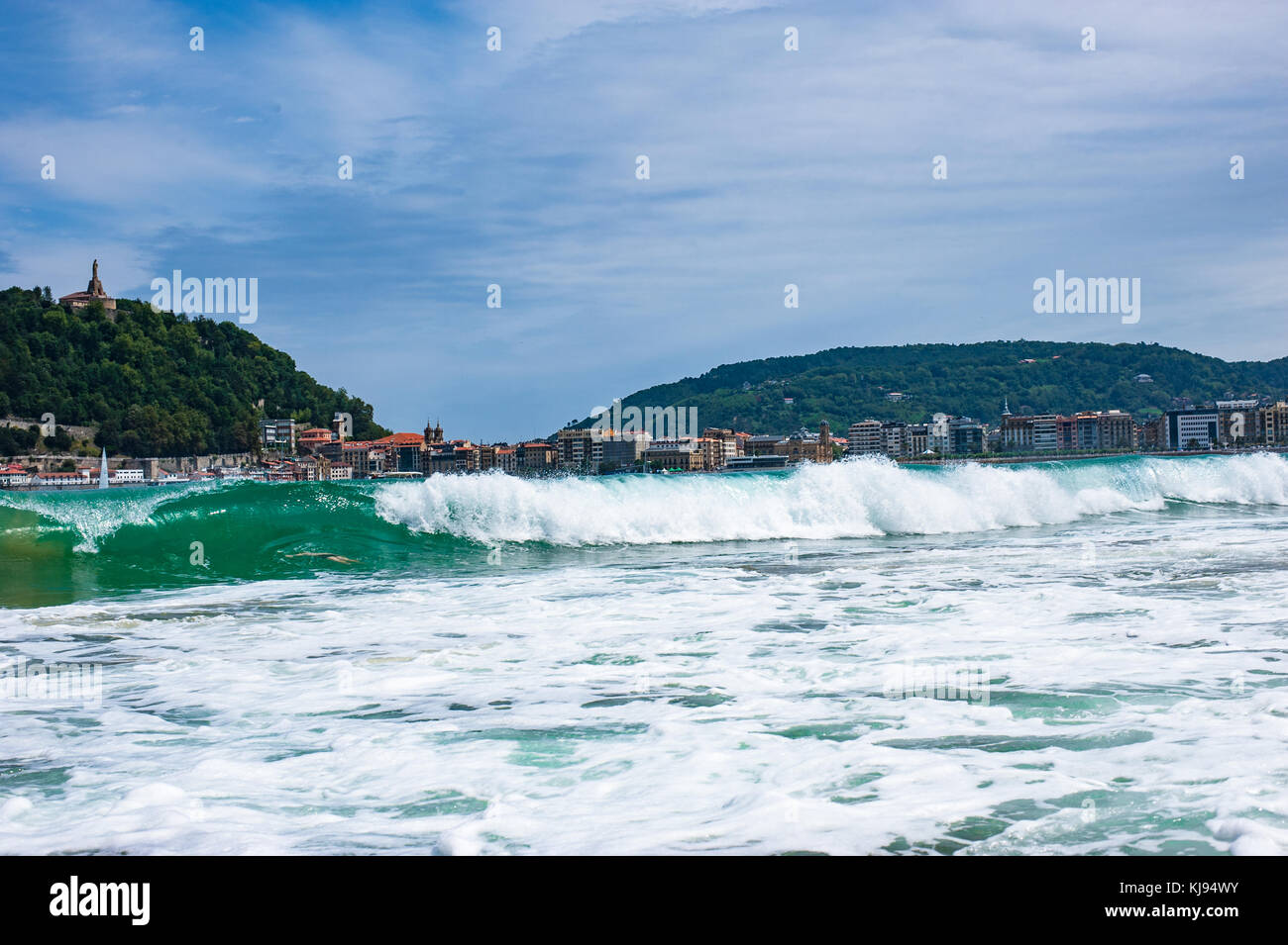 Beautiful turquoise waves crushing on a beach of a small Spanish town ...