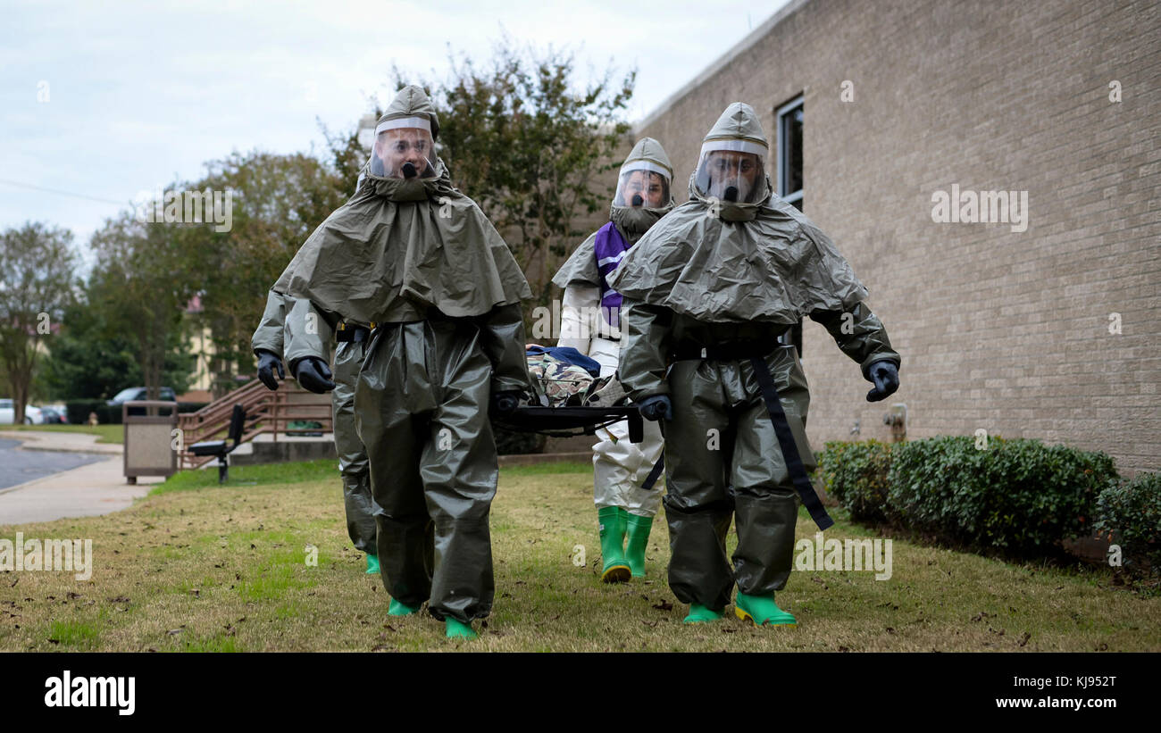 Decontamination team members from the 2nd Medical Group carry a ...