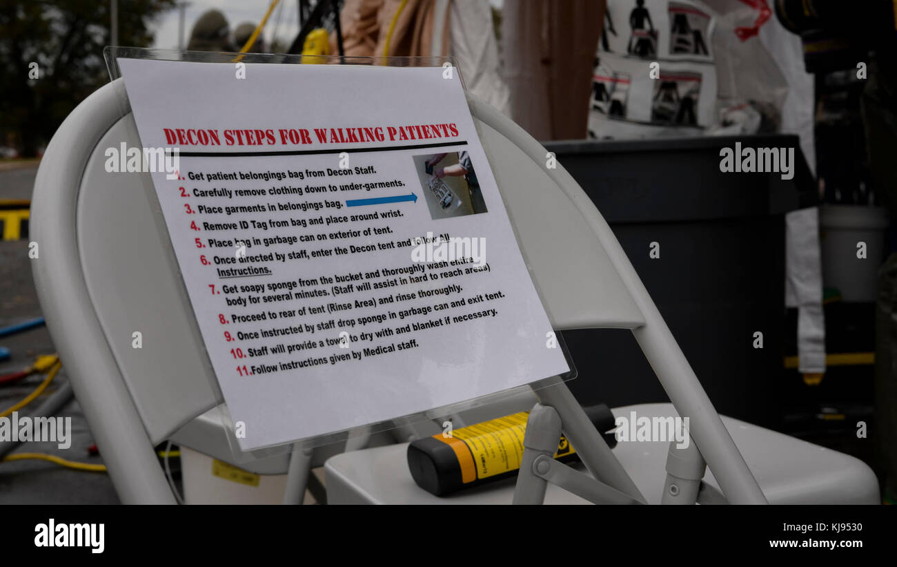 A chair with a sign displaying a decontamination process is set up at ...