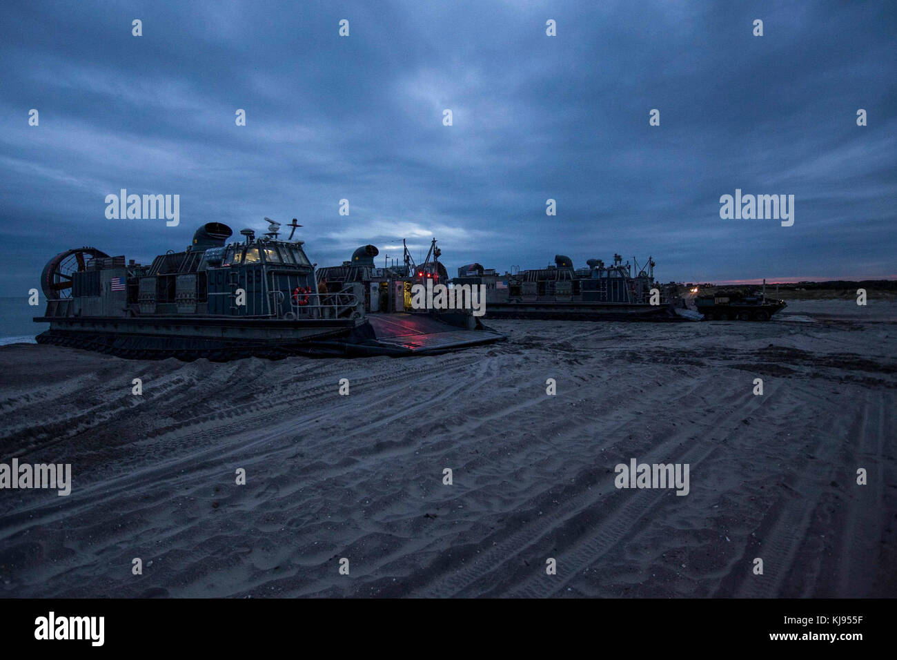 Landing craft, utility boats (LCU) land on Onslow Beach carrying U.S ...