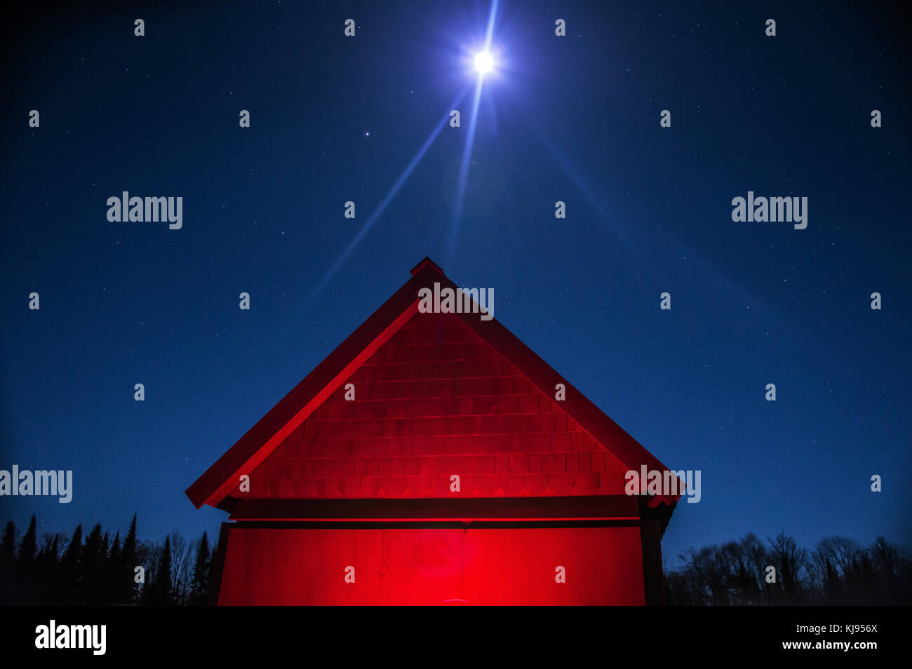 Red barn lit up against a full moon at night, Michigan, USA Stock Photo ...