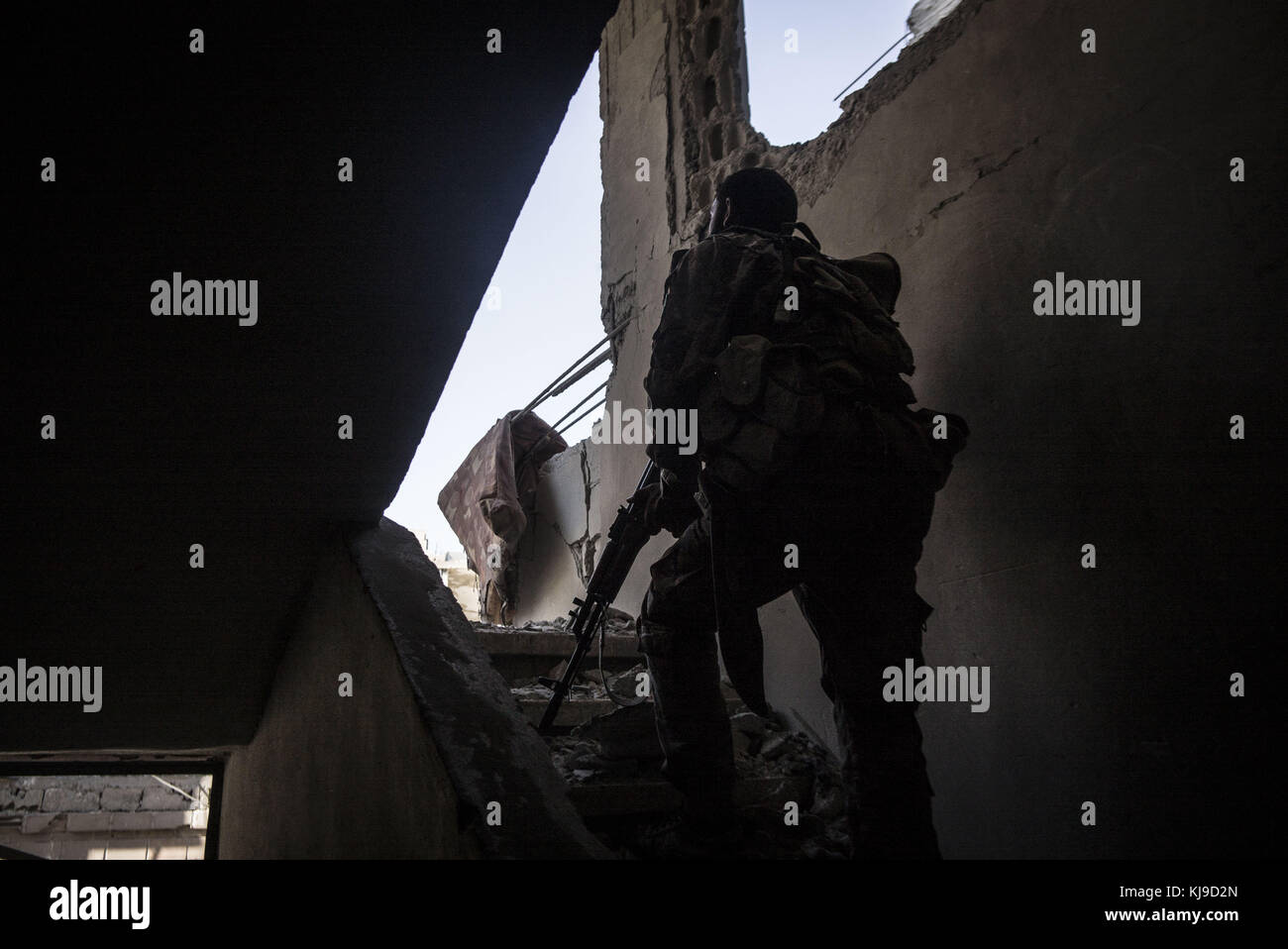 Raqqa, Syria. 12th Aug, 2017. SDF fighter checks out a higher position ...