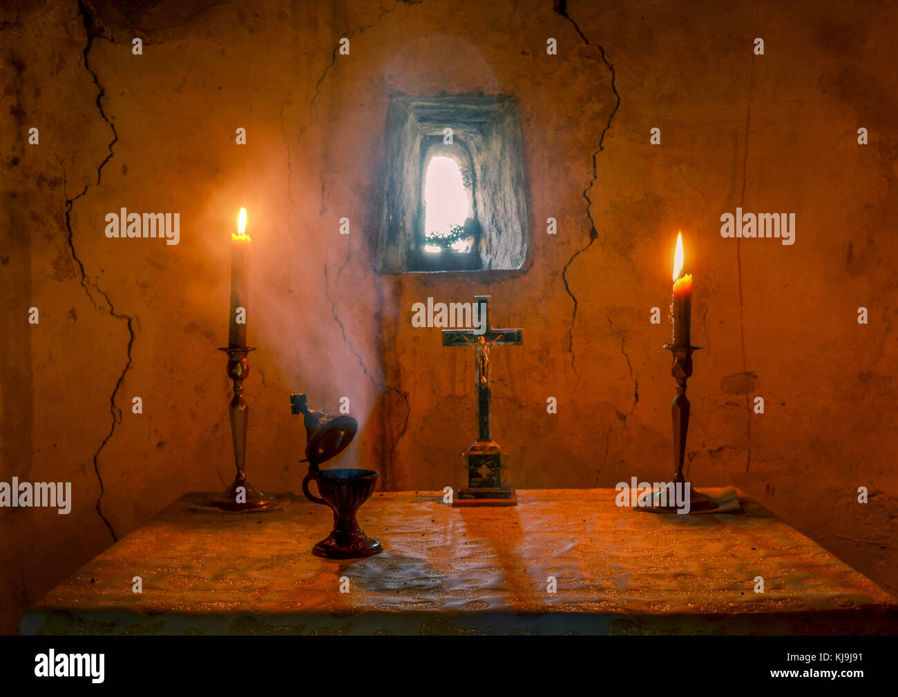 inner sanctuary of a chapel with burning candles, the flame of censer ...