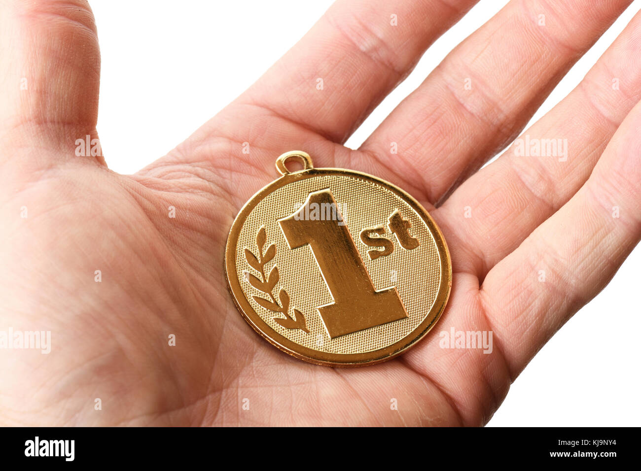 Hand holding out a 1st place gold badge isolated on a white background ...