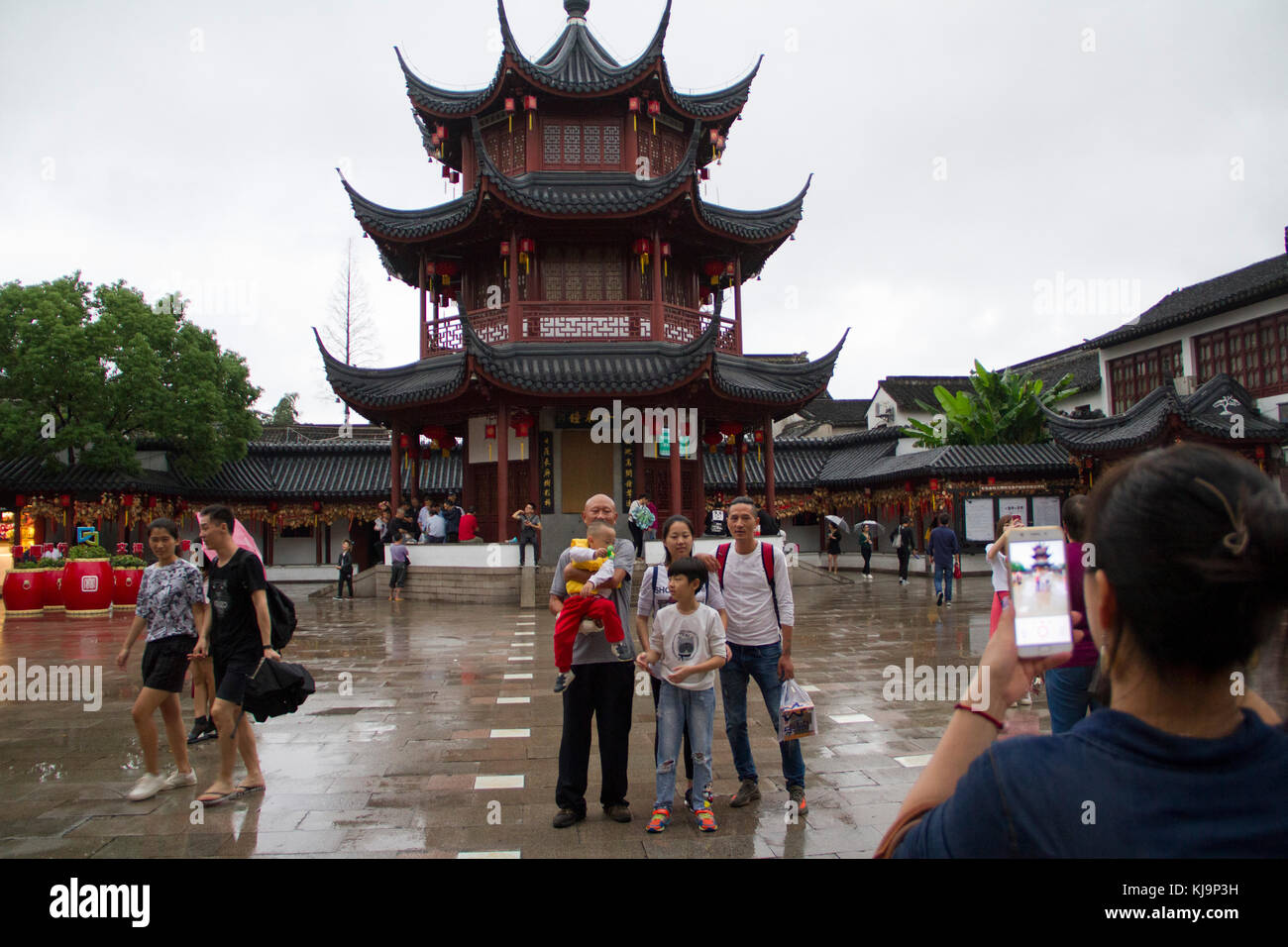 People walk through the ancient settlement of Qabio in the Minhang ...