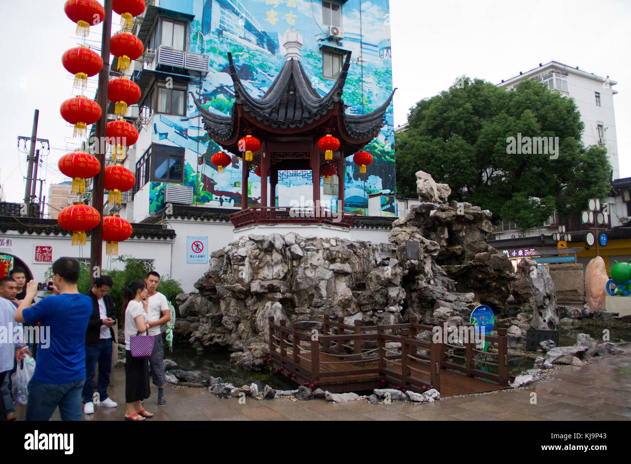 People walk through the ancient settlement of Qabio in the Minhang ...