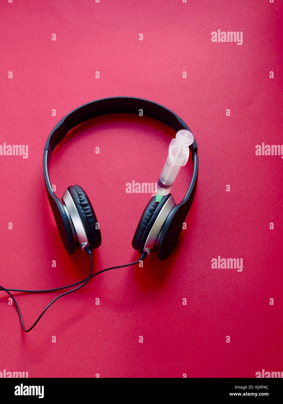 Headphone with syringe on red background - Addict to music concept ...