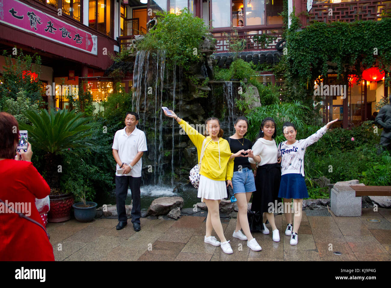 People take photos in the ancient settlement of Qabio in the Minhang ...