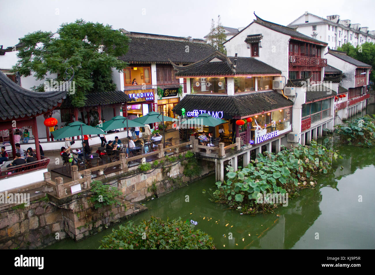 People walk past waterways in the ancient settlement of Qabio in the ...