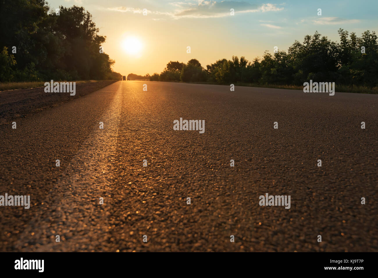 sun over asphalt road. soft focus in center of photo Stock Photo - Alamy