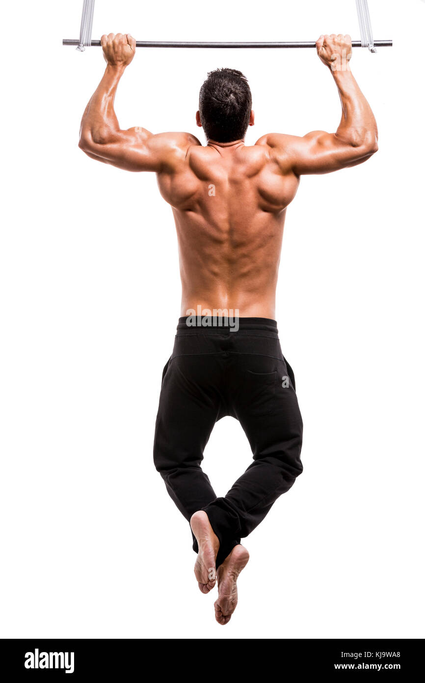 Muscle man in studio making elevations, isolated over a white ...