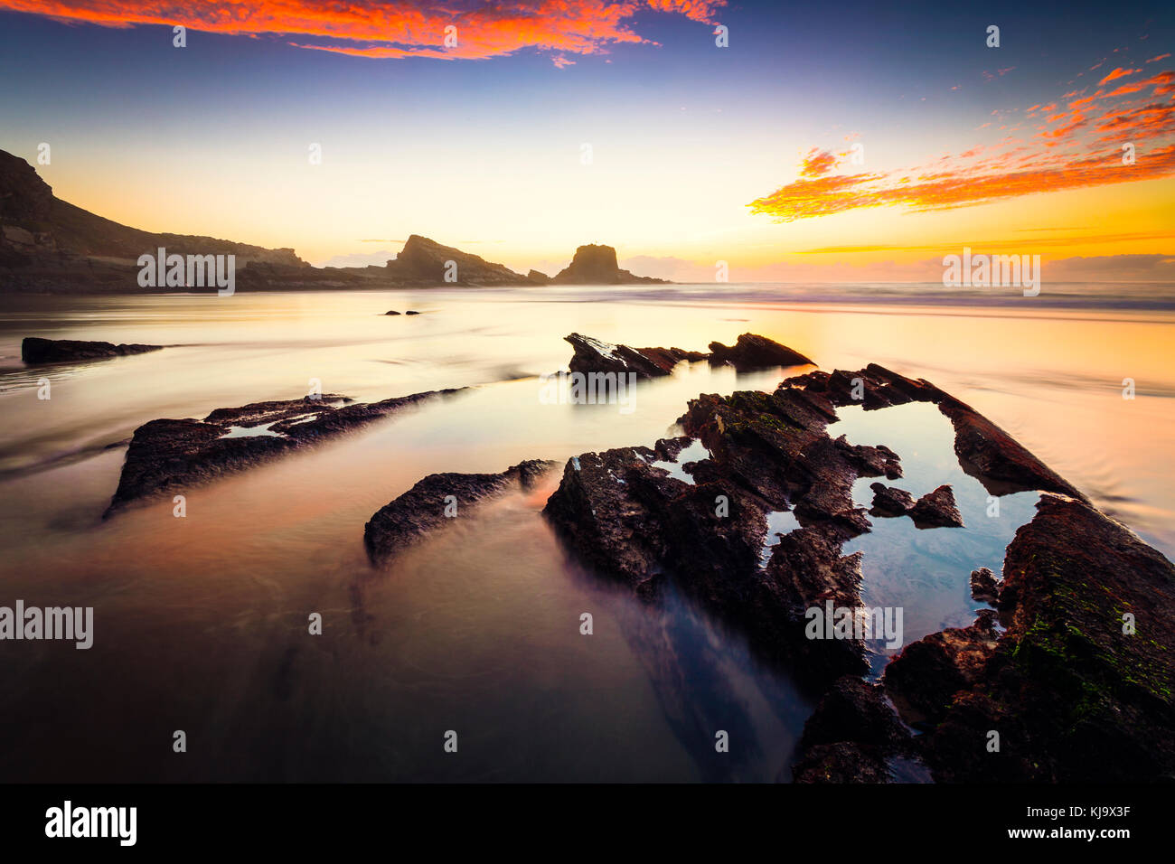 Beautiful orange sunset at the beach Stock Photo - Alamy