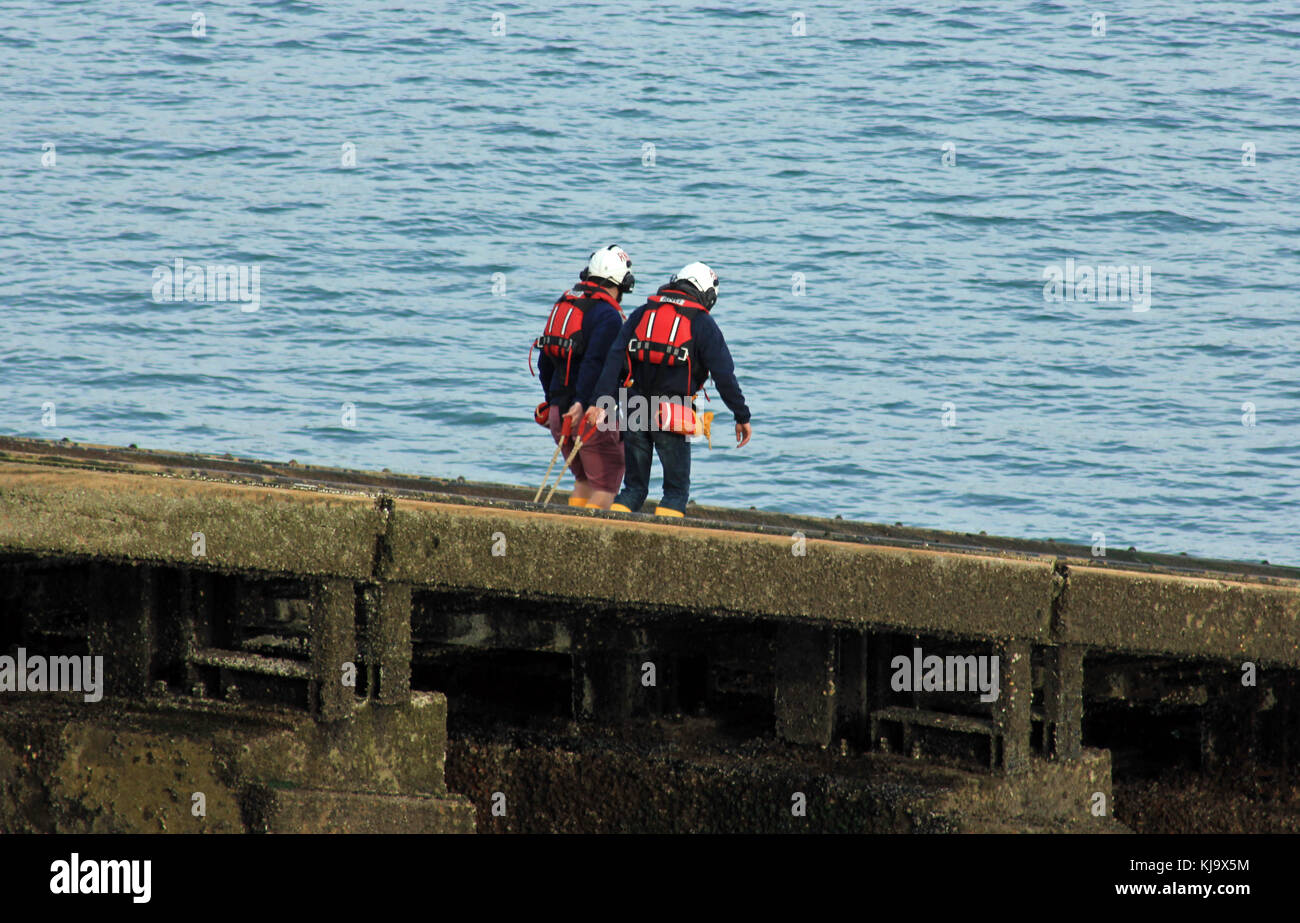 Two members from the crew of the Tenby lifeboat drag the synthetic ...