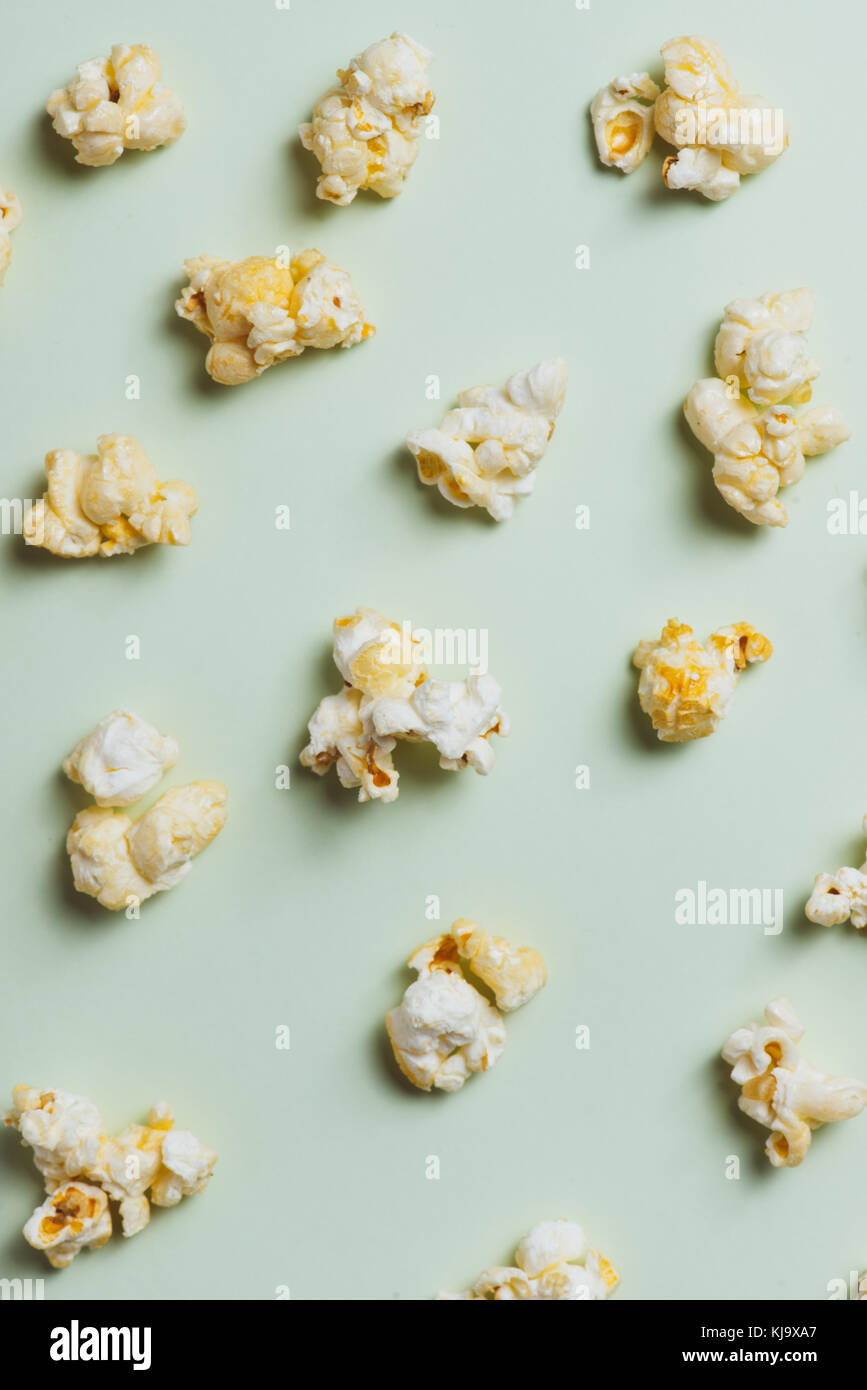 The popcorn in paper cup on green background Stock Photo - Alamy