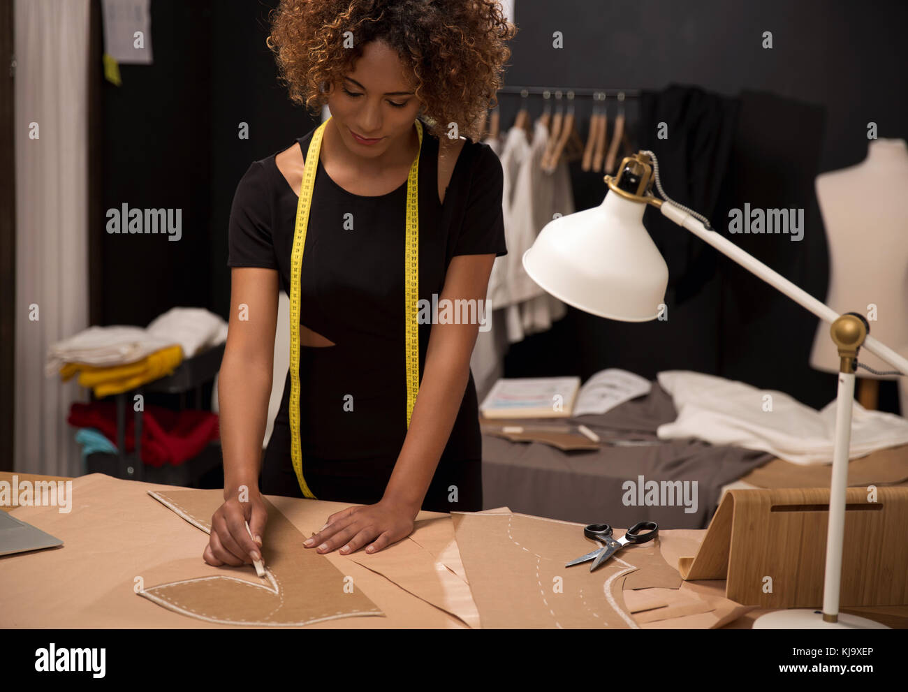 A young fashion designer working on her atelier Stock Photo - Alamy