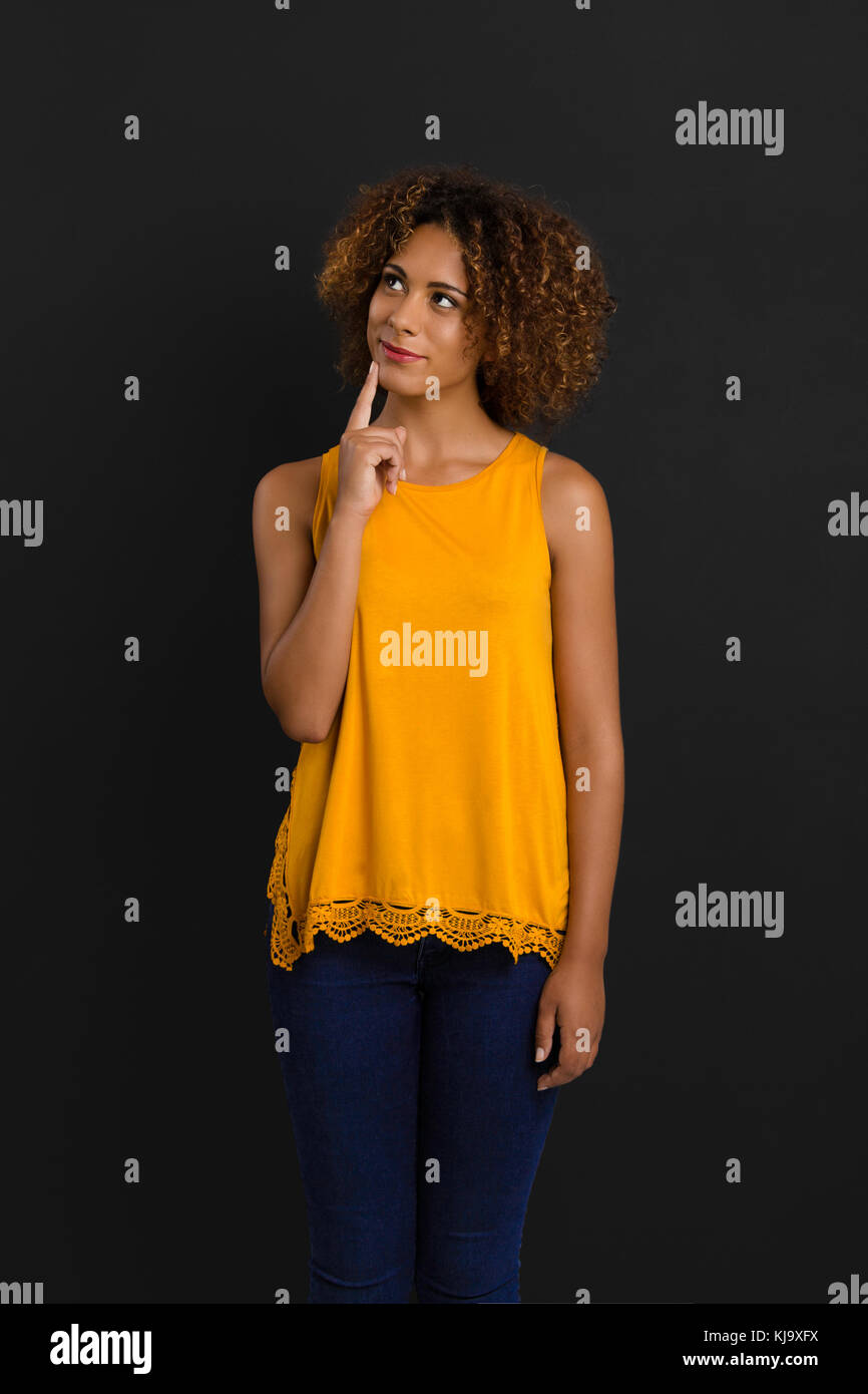 Beautiful African American woman with a thinking expression Stock Photo ...