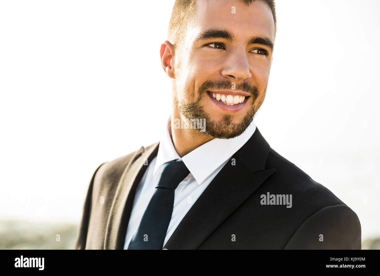 Good look young man in outdoor wearing a suit and smiling Stock Photo ...