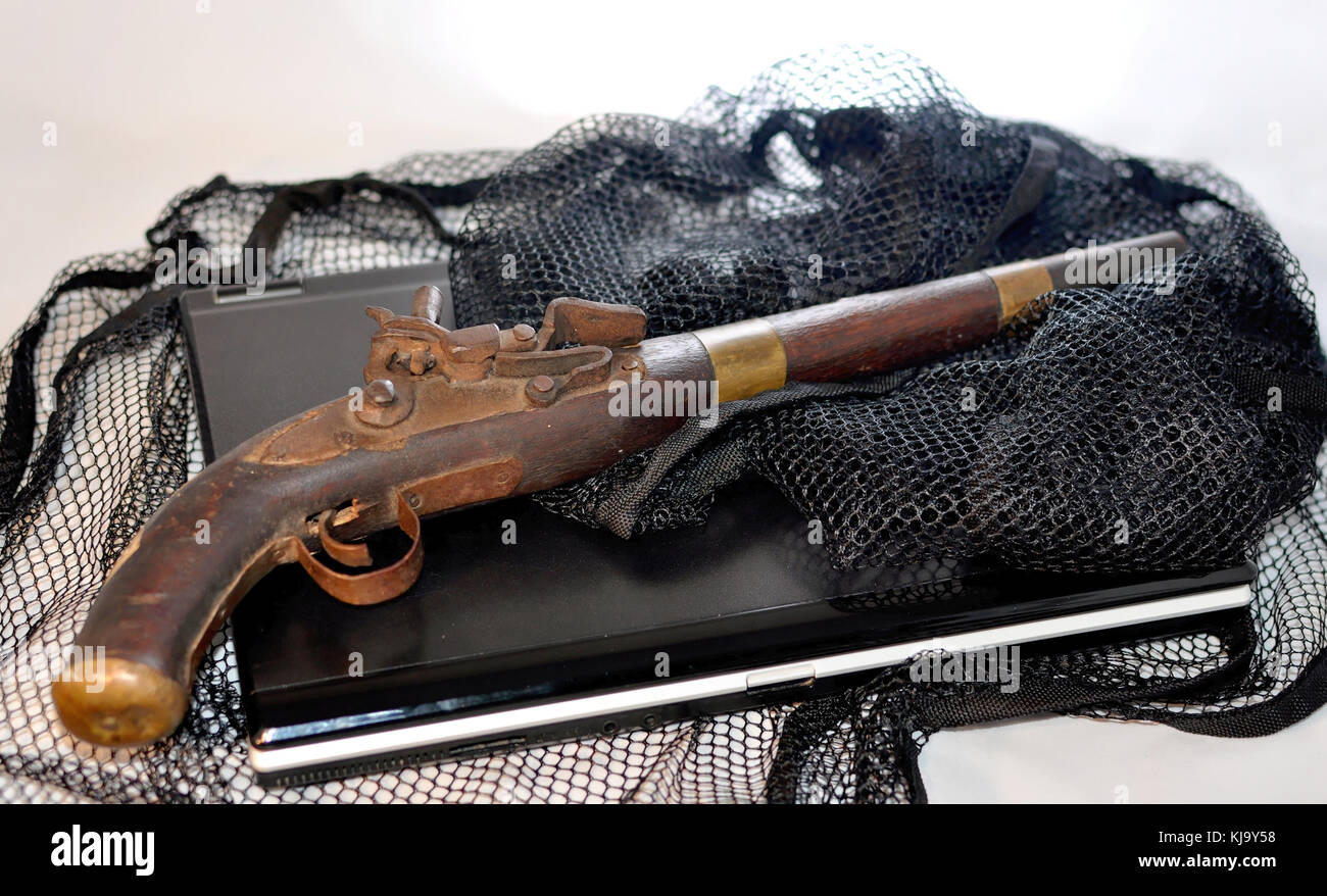 Laptop in web with gun and knife nternet data password security ...
