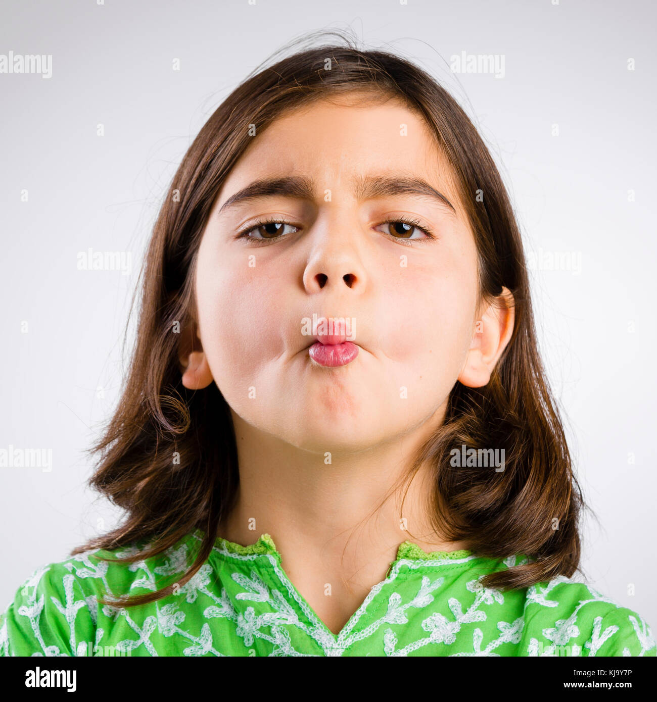 Portrait of a little girl making a fish mouth expression Stock Photo ...