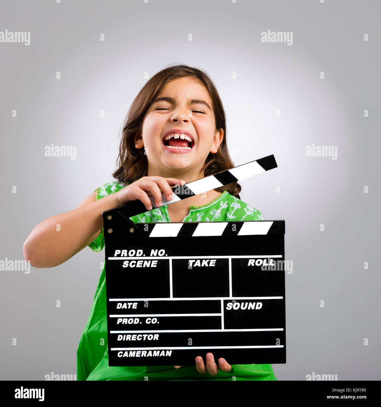 Studio portrait of a little girl playing as a young film director Stock ...