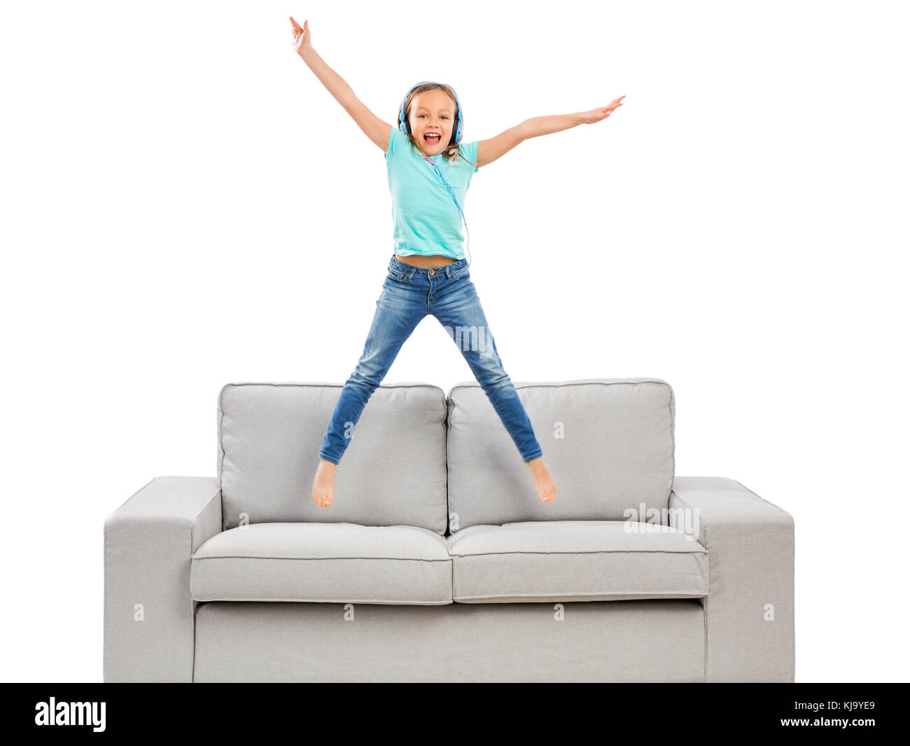 Cute blonde girl jumping and listen music Stock Photo - Alamy