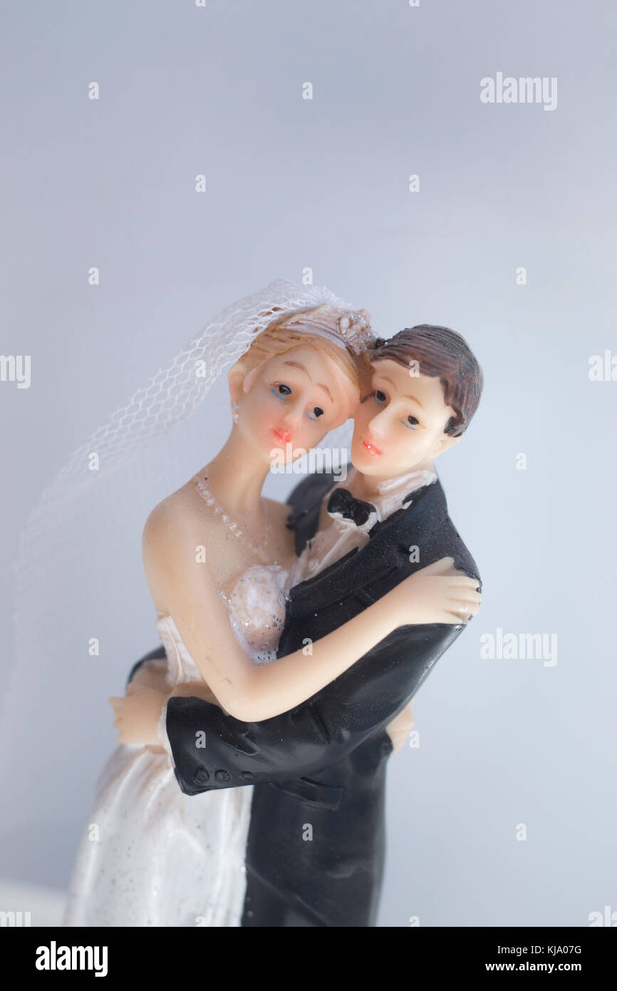 Bride and bridegroom wedding cake topper plastic statues holding after ...