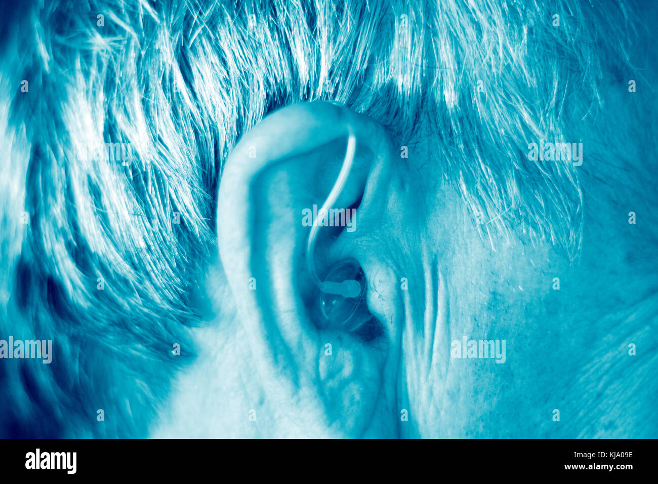 Digital modern hearing aid in the ear of aged old man Stock Photo - Alamy