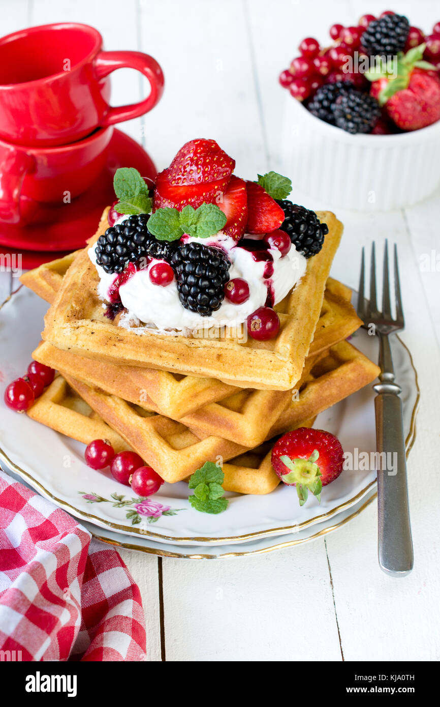 Waffles with berry fruits and vanilla cream in the plate,selective ...