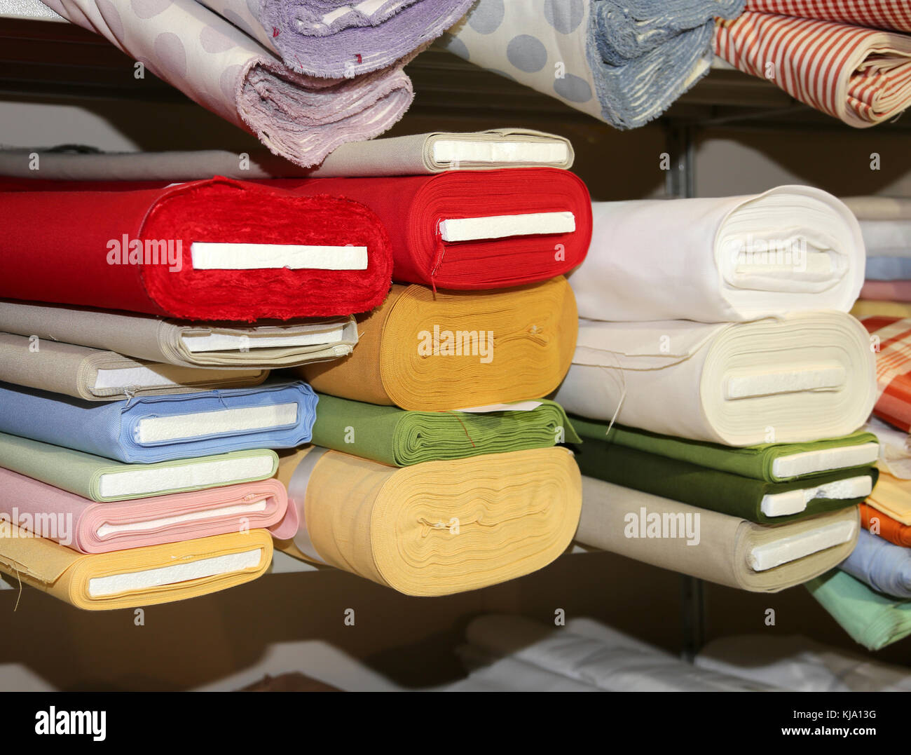 Haberdashery shelves with many types of fabric for sale Stock Photo - Alamy