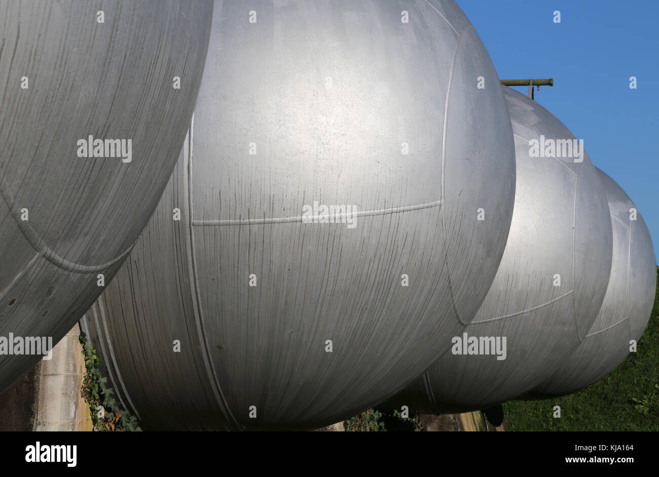 series of large metal tanks for gas storage inside an industrial area ...
